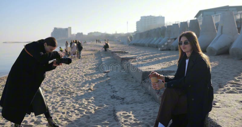 Photographer and Model on the Seashore Doing Photoshoot Stock Video ...