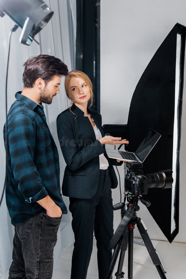 Photographer and Model Using Laptop and Looking at Each Other Stock ...