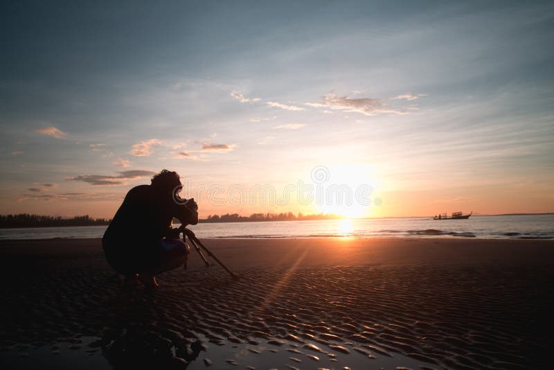 Photographer is Photographing the Sun Falling with His Camera Stock ...