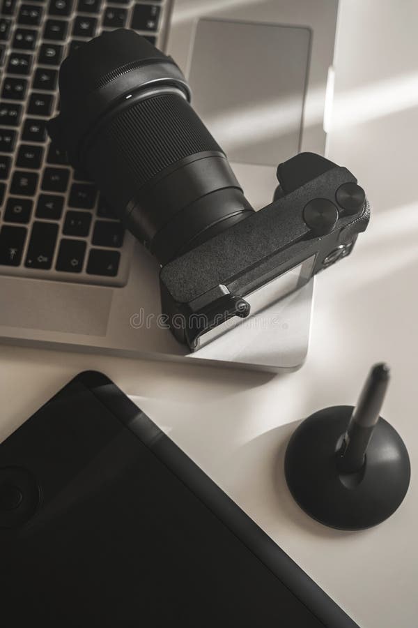 Photographer S Workplace with a Mirrorless Camera, Laptop and Graphics ...