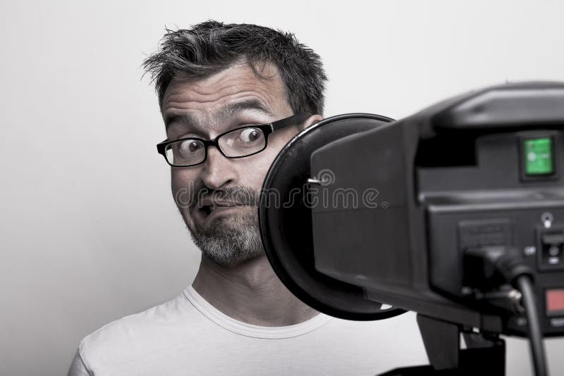 Photographer Sceptically Looks into a Studio Strobe Stock Image - Image ...