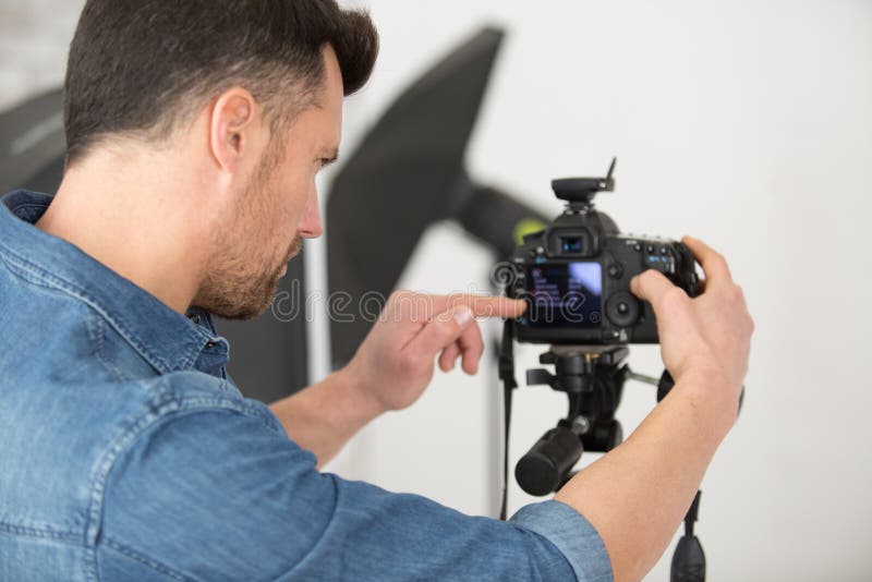 Photographer in Studio Adjusting Settings on Camera Stock Image - Image ...