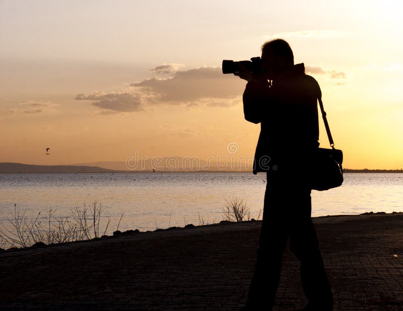Photographer and sunset stock image. Image of photographer - 30825657