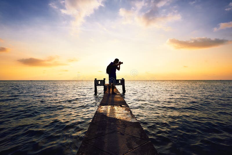 Photographer at the sunset stock image. Image of seascape - 64992073