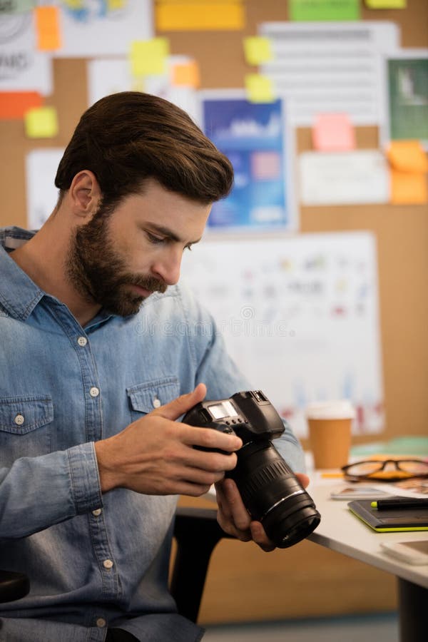 Photographer Using Camera in Creative Office Stock Image - Image of ...