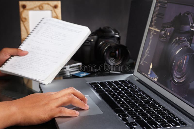 Photographer using laptop stock image. Image of card - 16062027