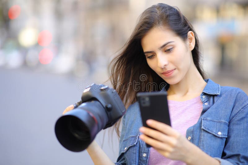 Photographer Using Phone Holding Camera Stock Image - Image of outdoor ...