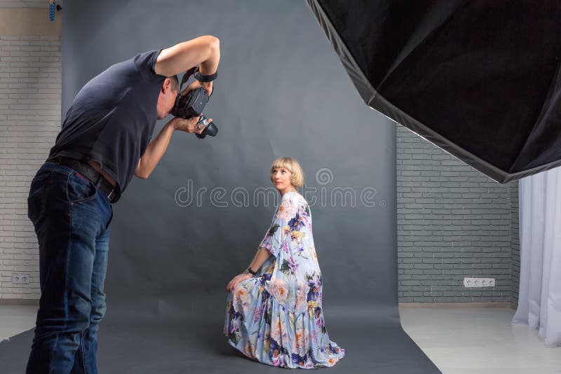 Photographer Works with a Client in the Studio Stock Photo - Image of ...