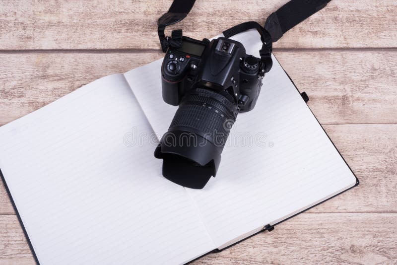 Photographers Workplace with Book and Camera on Wooden Table Stock ...