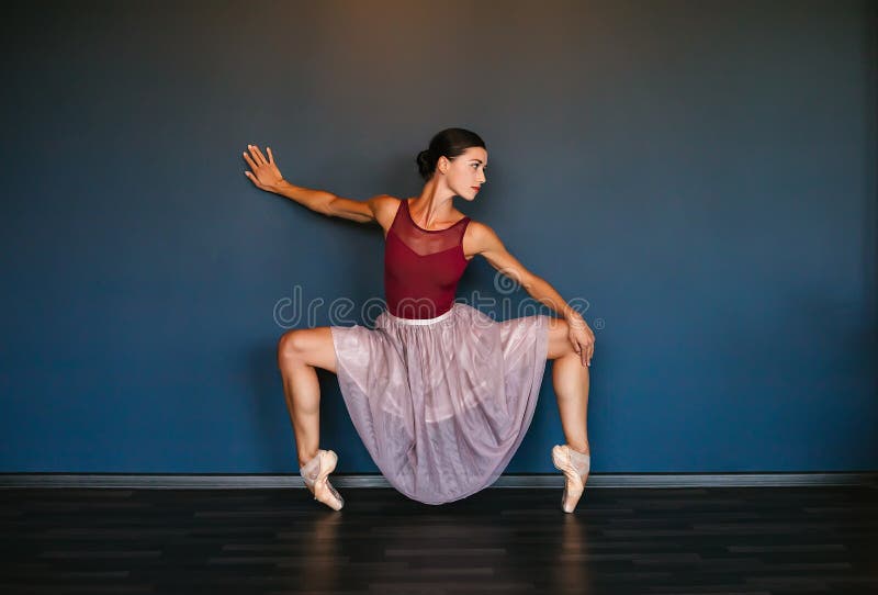 Modern Ballet Dancer Performing Ballet Exercise on Dark Studio ...
