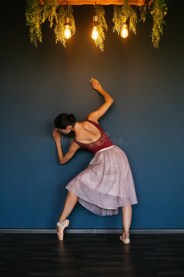 Modern Ballet Dancer Performing Ballet Exercise on Dark Studio ...