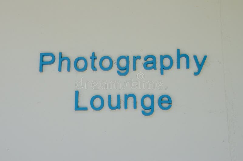 Photography Lounge Sign on White Wall Stock Image - Image of letters ...