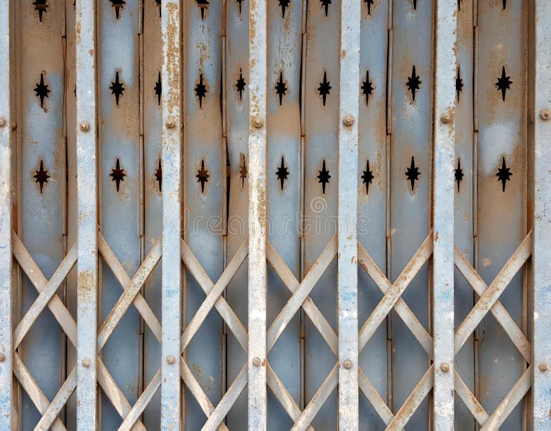 A Photography of a Metal Gate with a Pattern of Stars on it, There is a ...