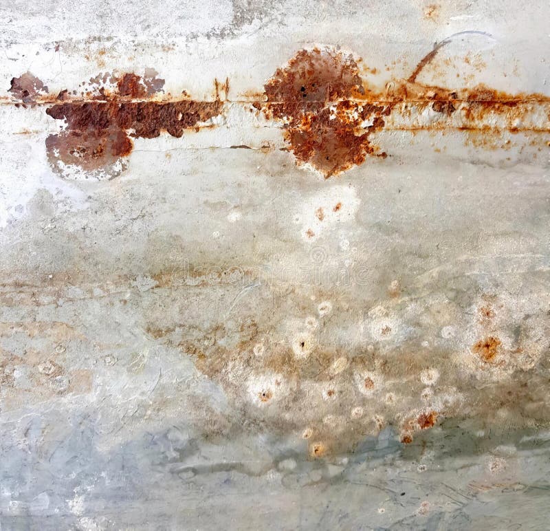 A Photography of a Rusted Wall with a Rusted Arrow on it, There is a ...