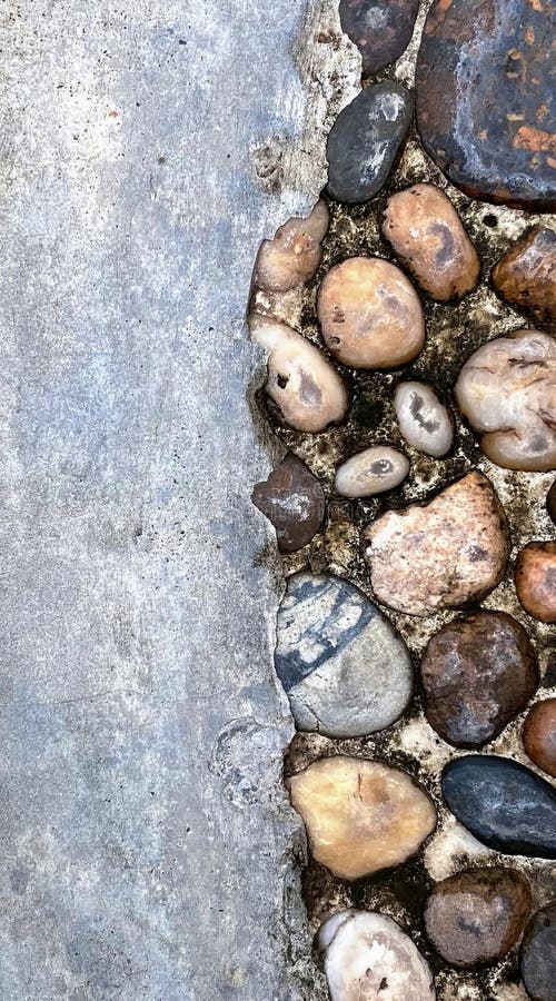 A Photography of a Stone and Metal Surface with a Few Rocks, Stone Wall ...