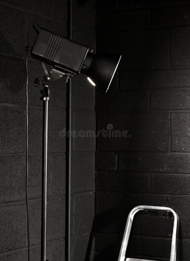 Photography Studio Light Against a Black Brick Wal Stock Photo - Image ...