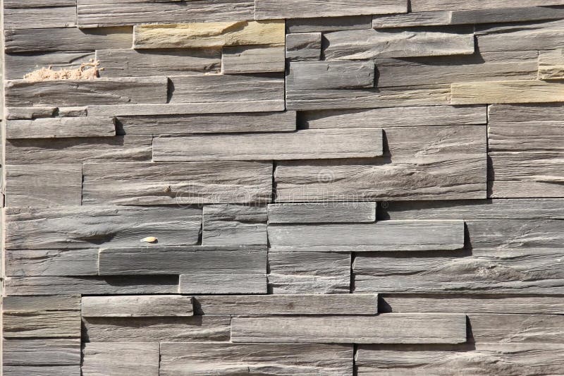 A Photography of a Wall Made of Stone Blocks with a Small Yellow Dot, a ...