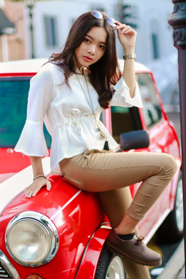 Photography Of A Woman Leaning On The Car Picture. Image: 115628332