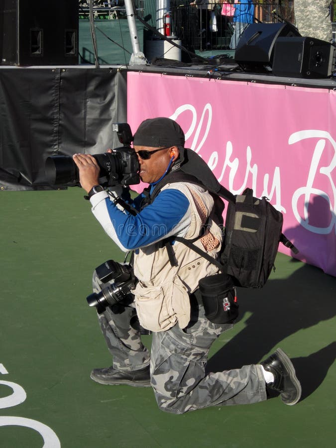 Photojournalist at Work editorial stock image. Image of backpack - 24236929