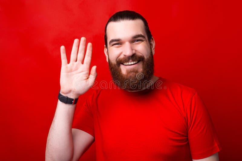 Photot of a Man Waving at the Camera and Smiling As a Hello Stock Photo ...