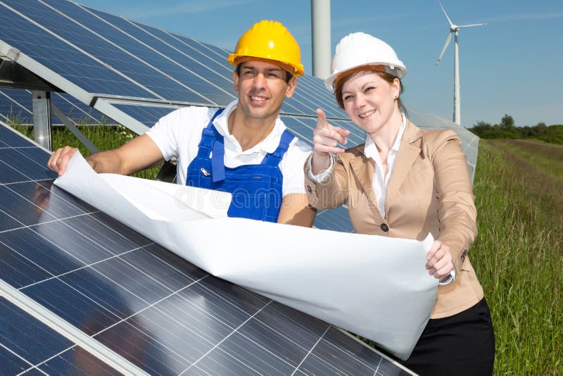 Photovoltaic Engineers with Construction Plan at Solar Panels Stock ...