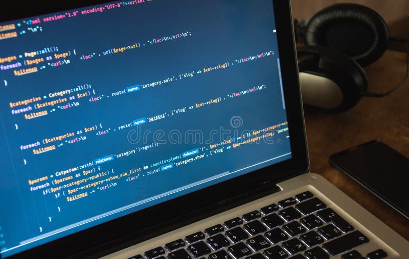 Php Code on Laptop`s Display with Cellphone and Earphones on Working ...