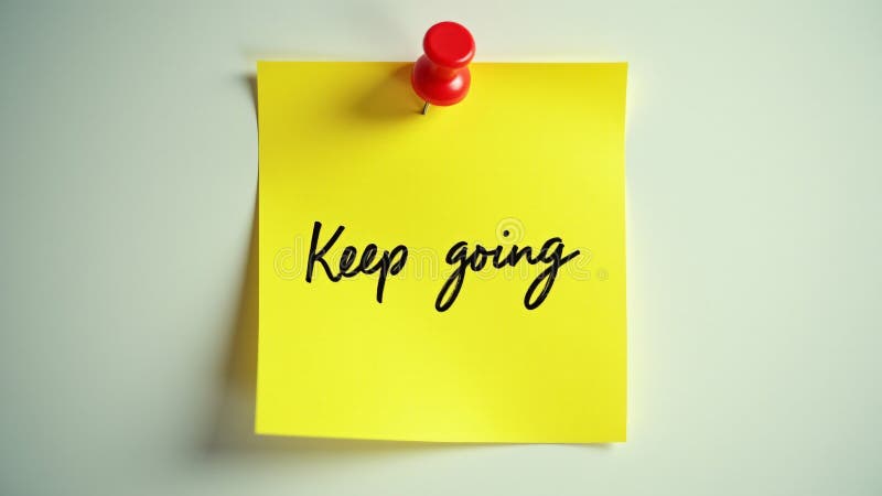 The Phrase Keep Going is Handwritten in Black Ink. Soft Lighting ...