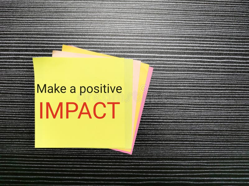Phrase Make a Positive Impact Written on Sticky Note on the Table ...