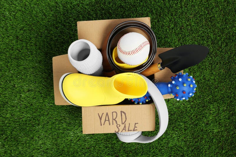 Phrase Yard Sale Written on Box with Different Stuff on Green Grass ...