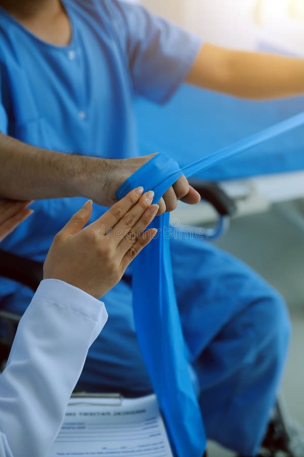 Physical Therapist Guiding Patient with Resistance Band Stock Photo ...
