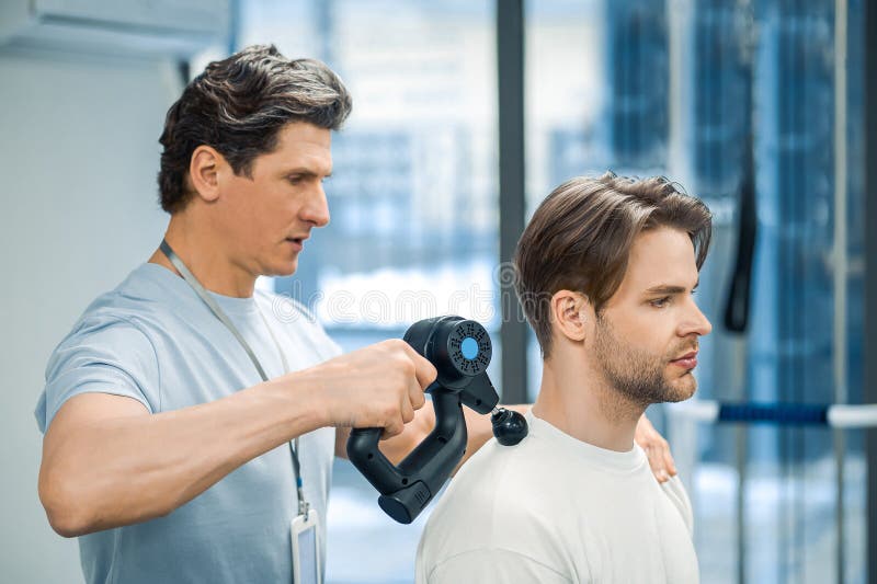 Physical Therapist Having a Treatment Session with a Patient Stock ...