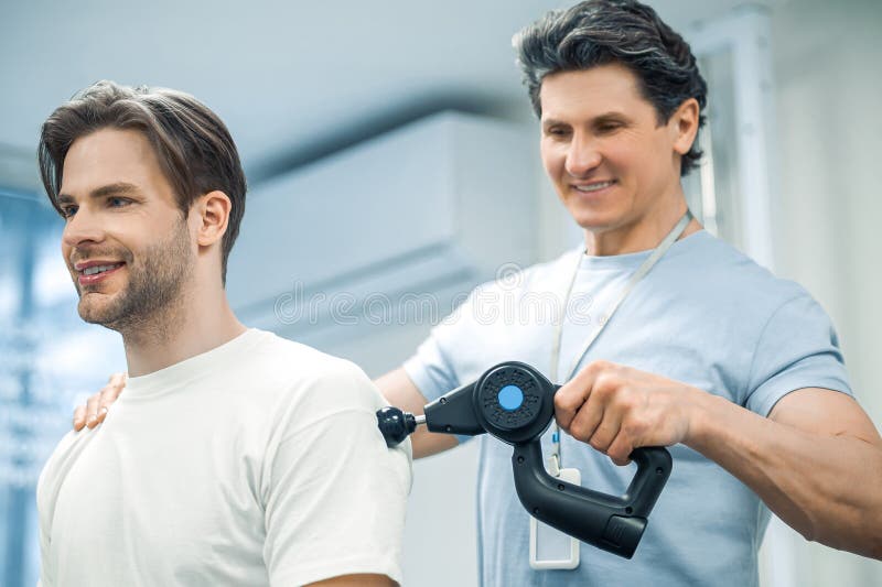 Physical Therapist Having a Treatment Session with a Patient Stock ...