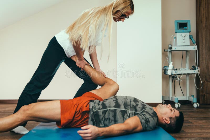 Physical Therapist Working with Male Patient Stock Image - Image of ...