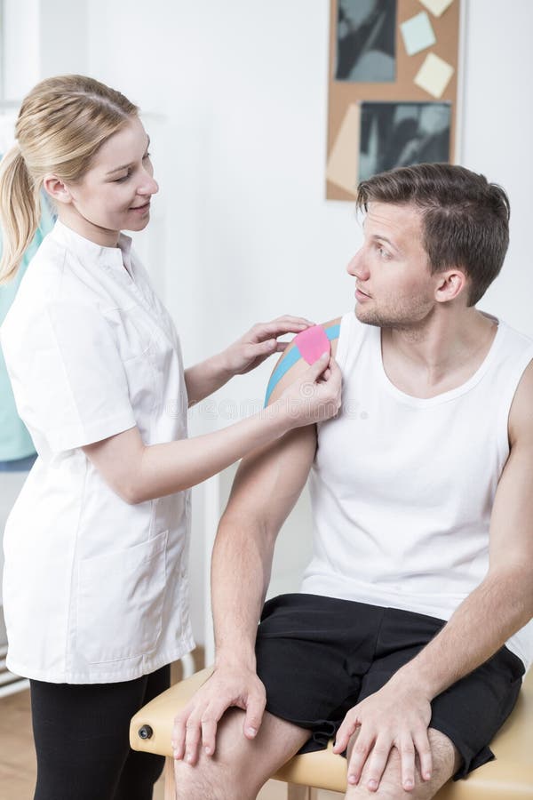 Physiotherapist Applying Kinesio Tape Stock Image - Image of room ...