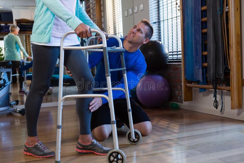 Physiotherapist Assisting Patient To Walk with Walking Frame Stock ...