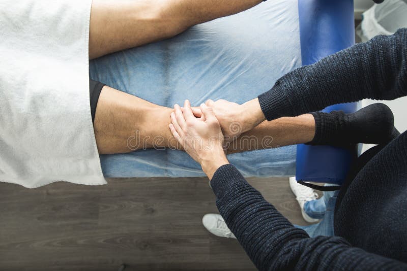 Physiotherapist Massaging A Young Man Calf Physiotherapy And