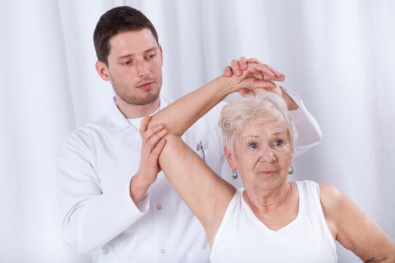 Physiotherapist Rehabilitating Elderly Woman Stock Photo - Image of ...