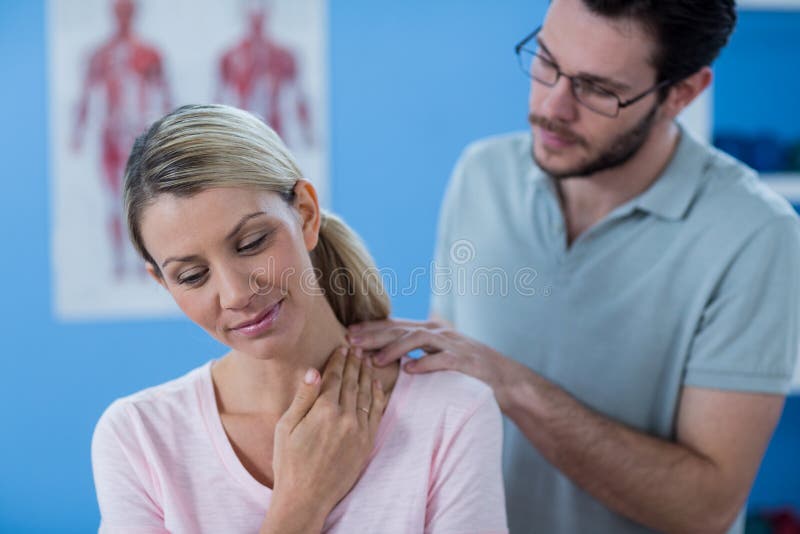 Physiotherapist Stretching Neck of a Female Patient Stock Photo - Image ...