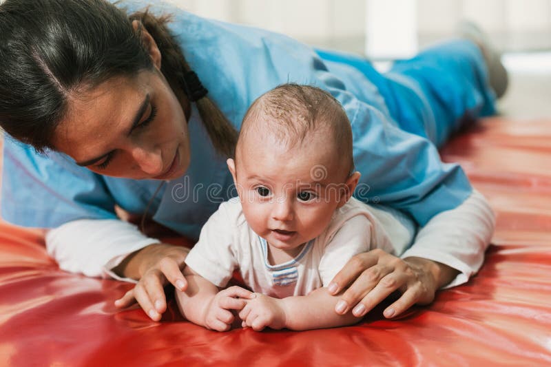 Physiotherapist Assisting Baby with Prone Position and Head Control ...