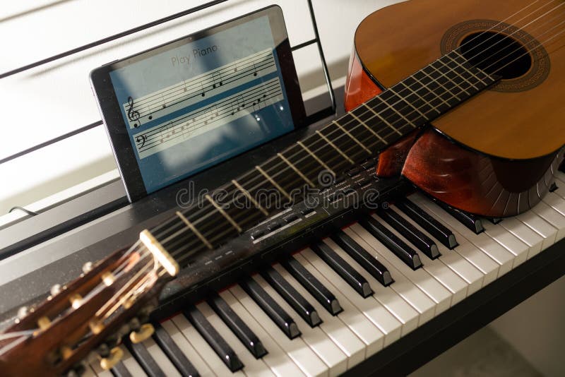 Piano Keyboard and Guitar. Tablet Stock Image - Image of freelance ...