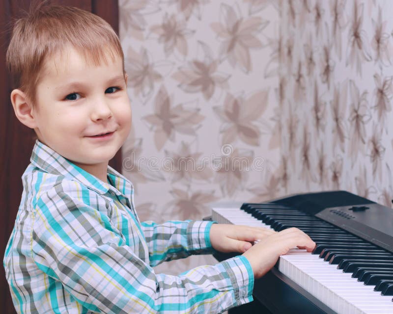 Piano Keys. Boy Receives Piano Lessons. Hands of the Boy on Piano Keys ...