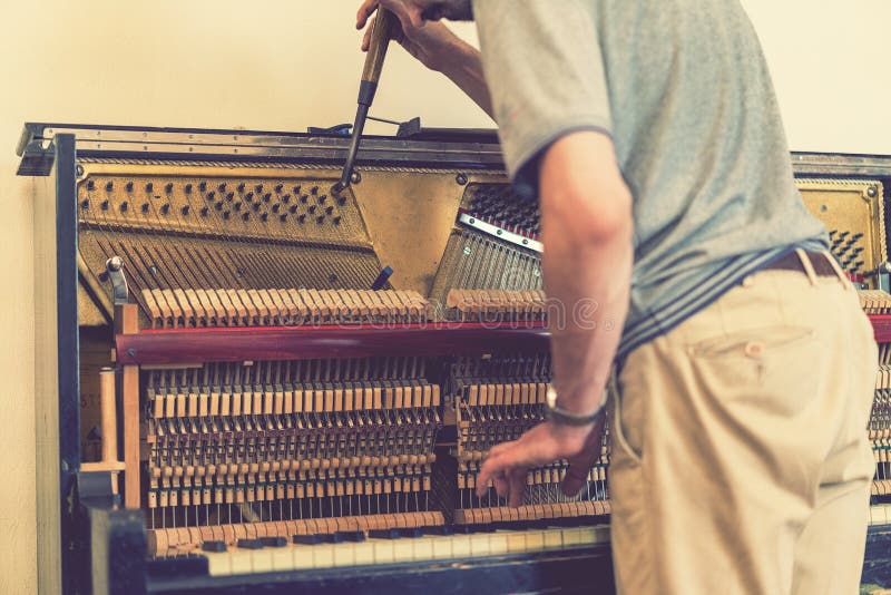 Piano Tuning Process. Closeup of Hand and Tools of Tuner Working on ...