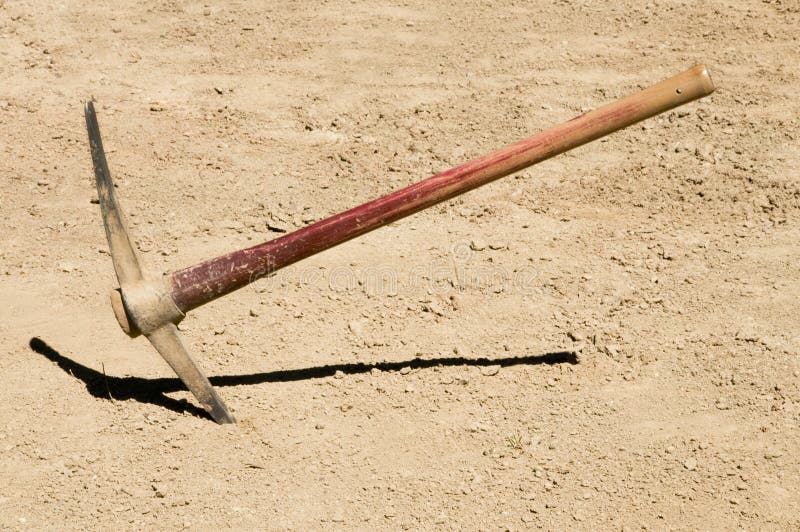 A Pick Axe Digging A Bitcoin Out Of Sandy Ground Stock Photo - Image of ...