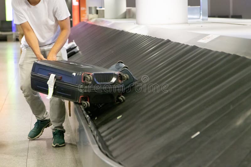 Pick Up Baggage from Luggage Carousel at Airport Stock Image - Image of ...