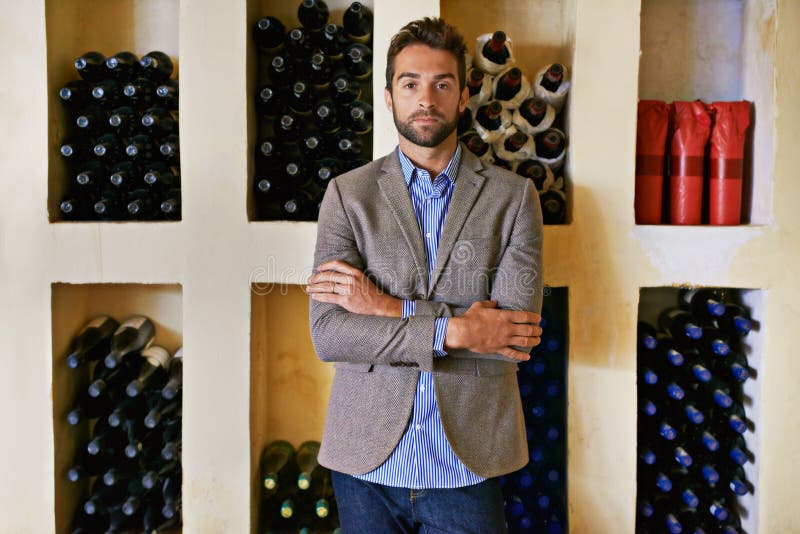 Pick Your Vintage. a Young Man Standing in Front of a Rack Full of Wine ...