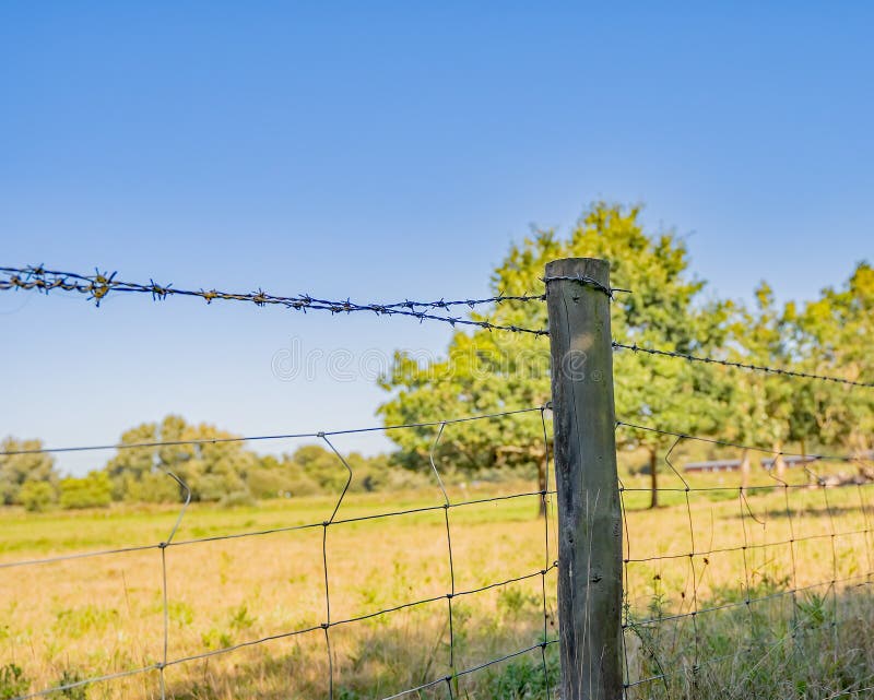 Picket Fence and Barbed Wire in the Rural Countryside Stock Image ...