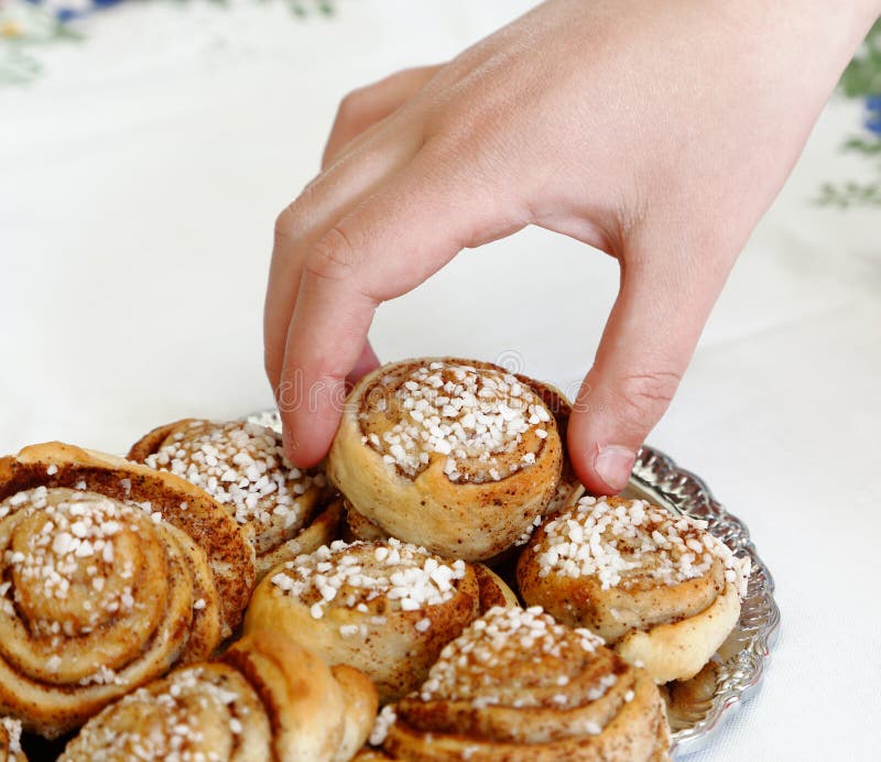 Picking cinnamon bun stock image. Image of close, grip - 57721999