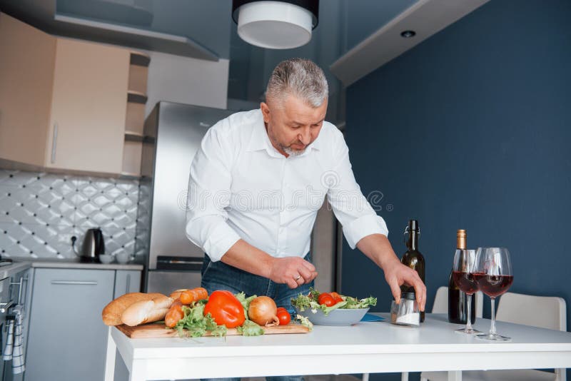 Picking Some Salt. Man in White Shirt Preparing Food on the Kitchen ...