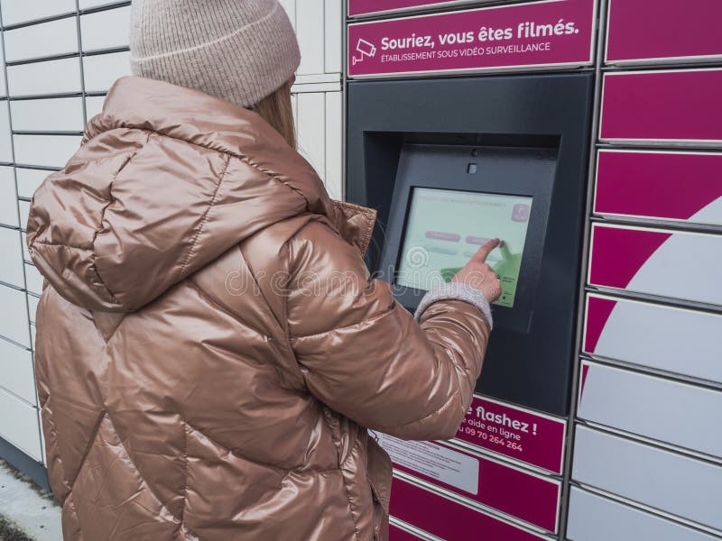 Picking Up A Parcel From A Mondial Relay Locker By A Young Woman Lockers Mondial Relay Pickup