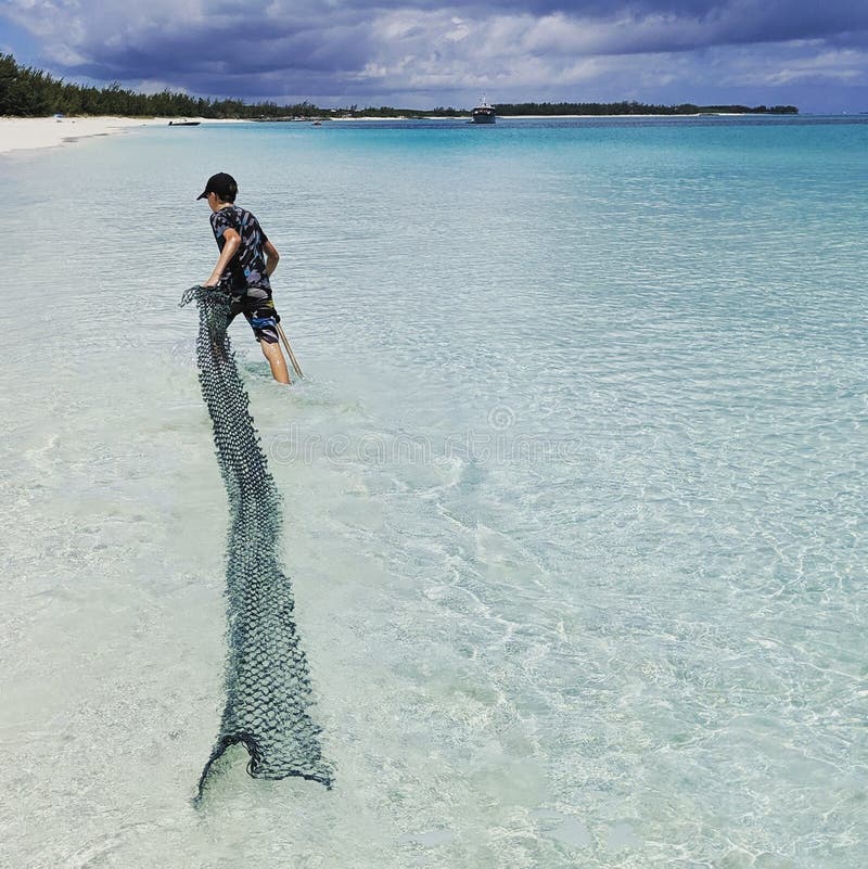 Picking Up Trash on the Beach in the Bahamas Stock Image - Image of ...
